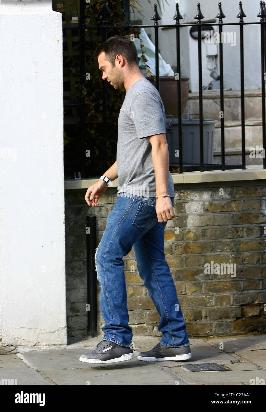 Tom Crane helps removal men move his furniture from his home London ...