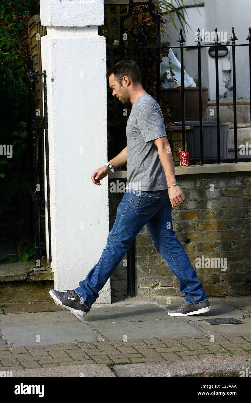 Tom Crane helps removal men move his furniture from his home London ...