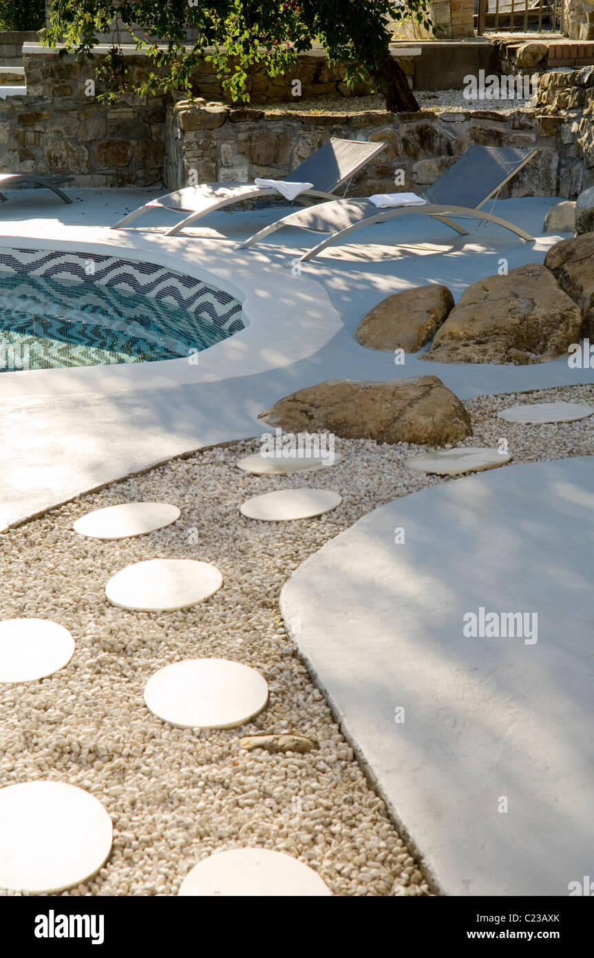 Gravel and stone path of poolside terrace with sunloungers Stock Photo ...