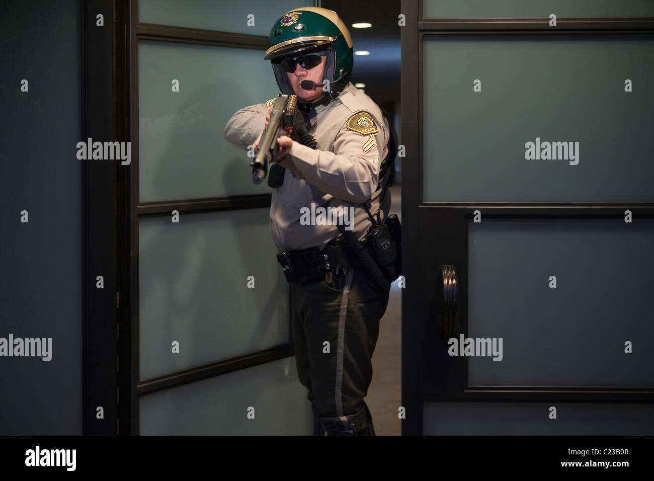 Nightwatch patrolman at doorway with rifle Stock Photo - Alamy