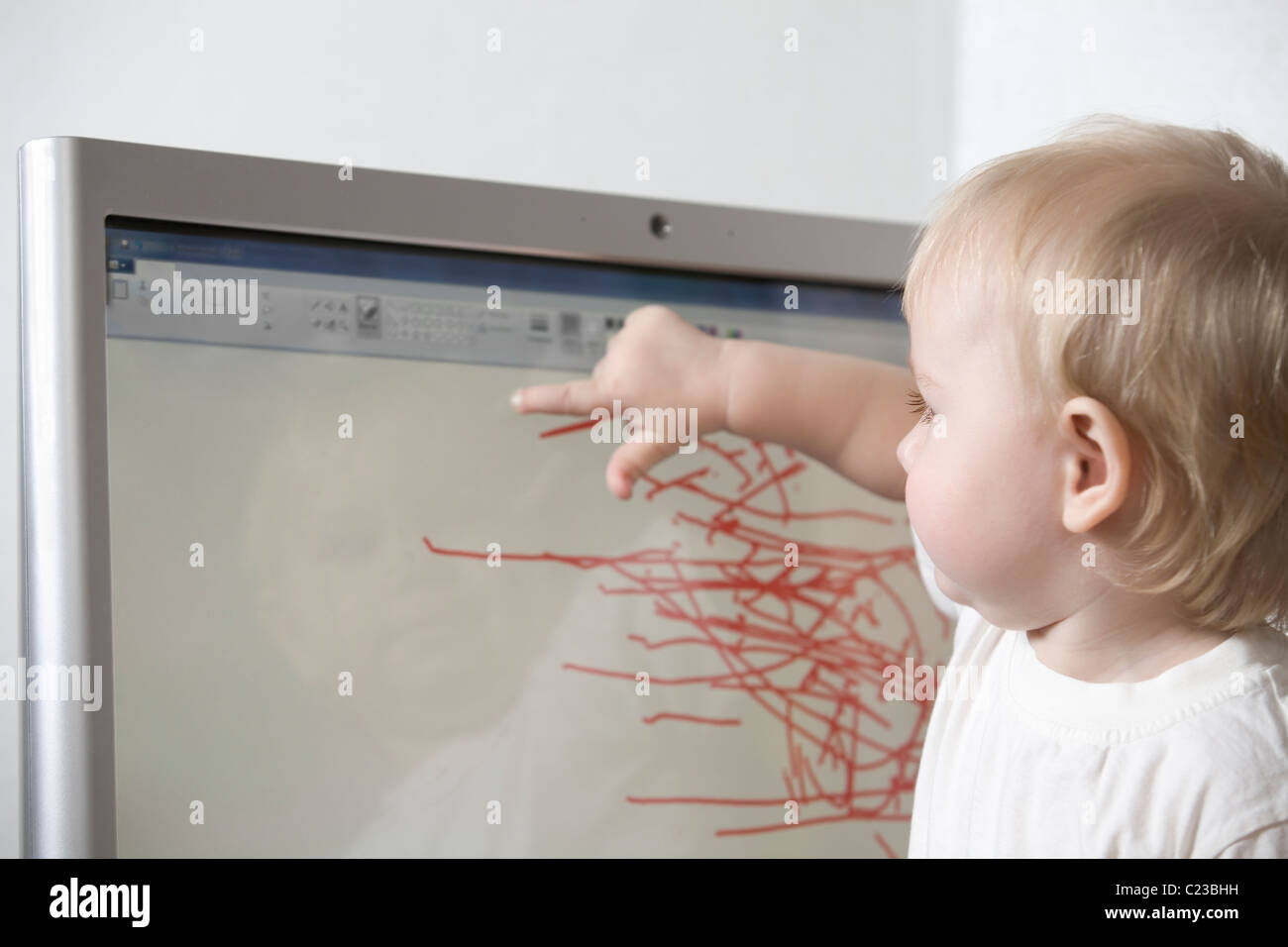 Child draws on computer with touch screen technology Stock Photo - Alamy