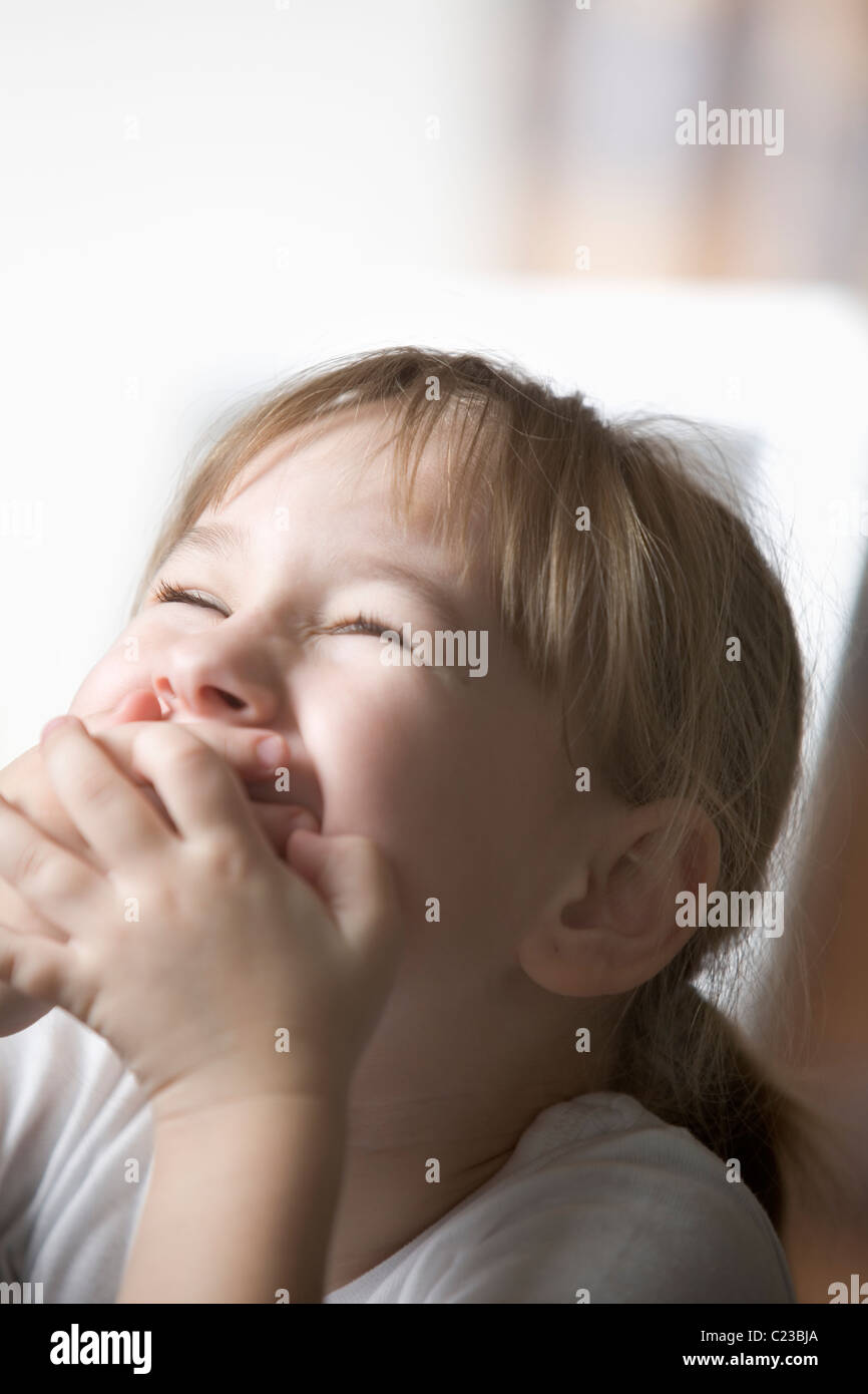 Girl laughing hands over mouth hi-res stock photography and images - Alamy