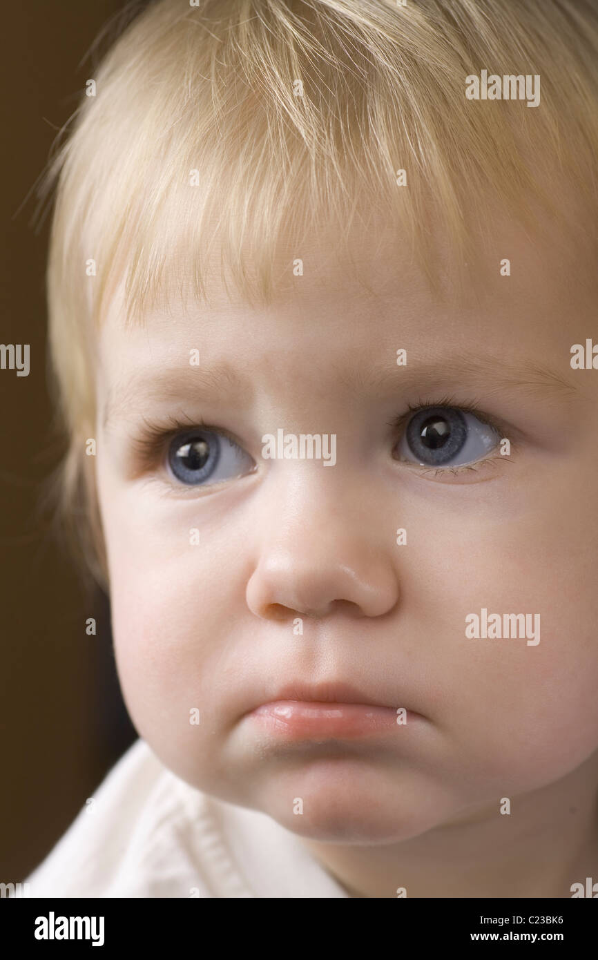Blonde 14 month old with downcast expression Stock Photo - Alamy