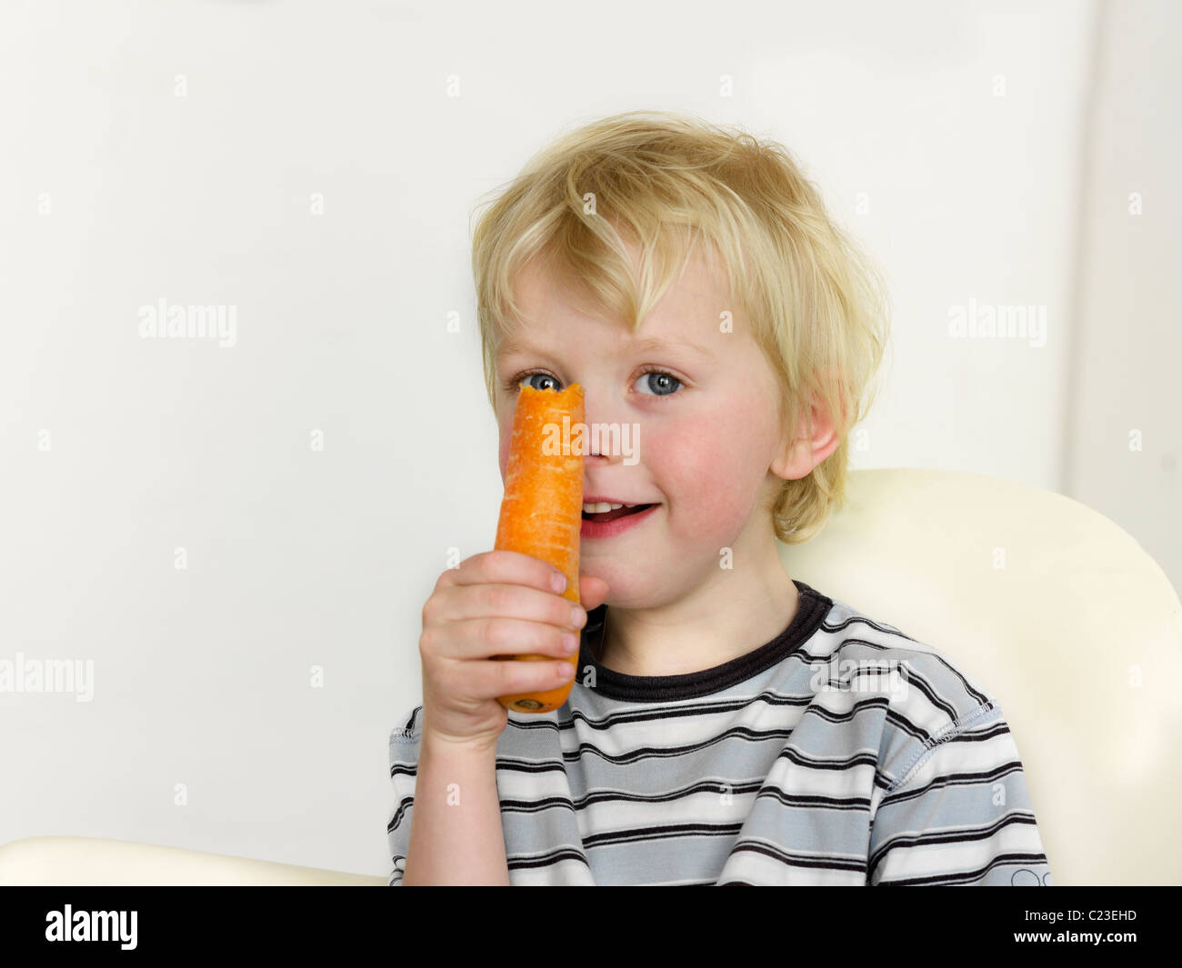 Young boy eating carrot Model release all media Stock Photo - Alamy