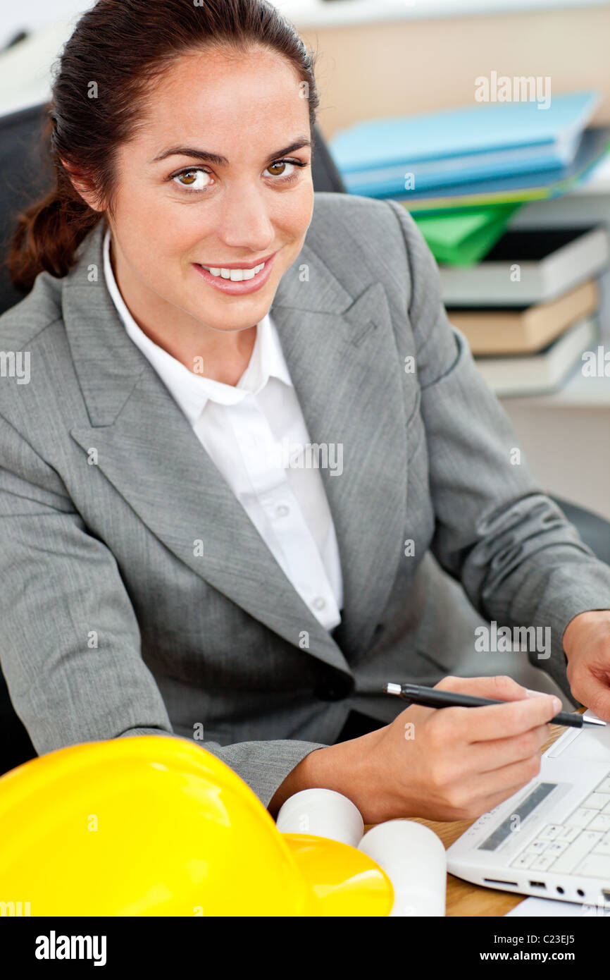 Delighted female architect working in her office Stock Photo - Alamy