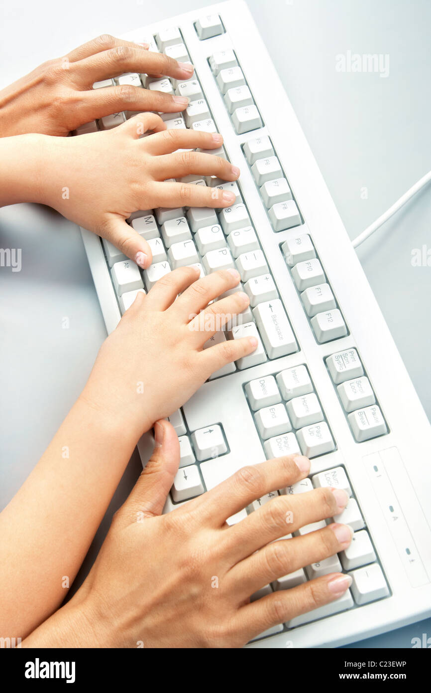 Close-up of mother study to use the keyboard her child Stock Photo - Alamy