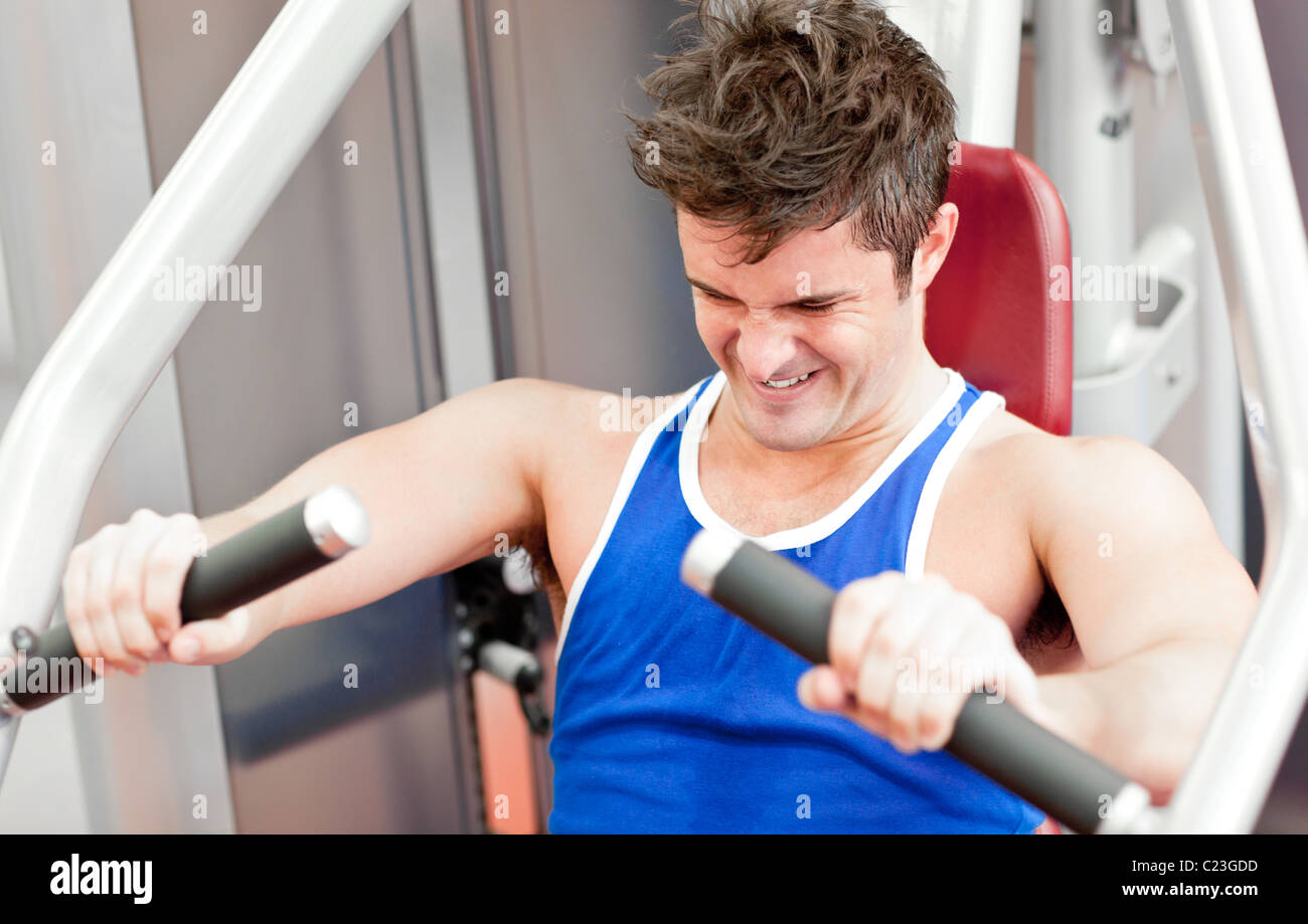 Strong athletic man using a bench press Stock Photo - Alamy