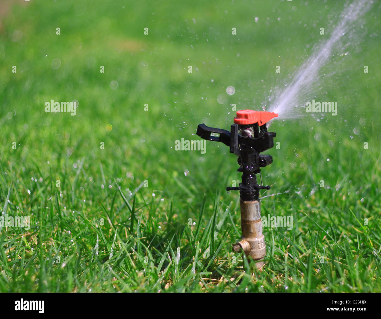 Automated sprinkler spraying water hi-res stock photography and images ...