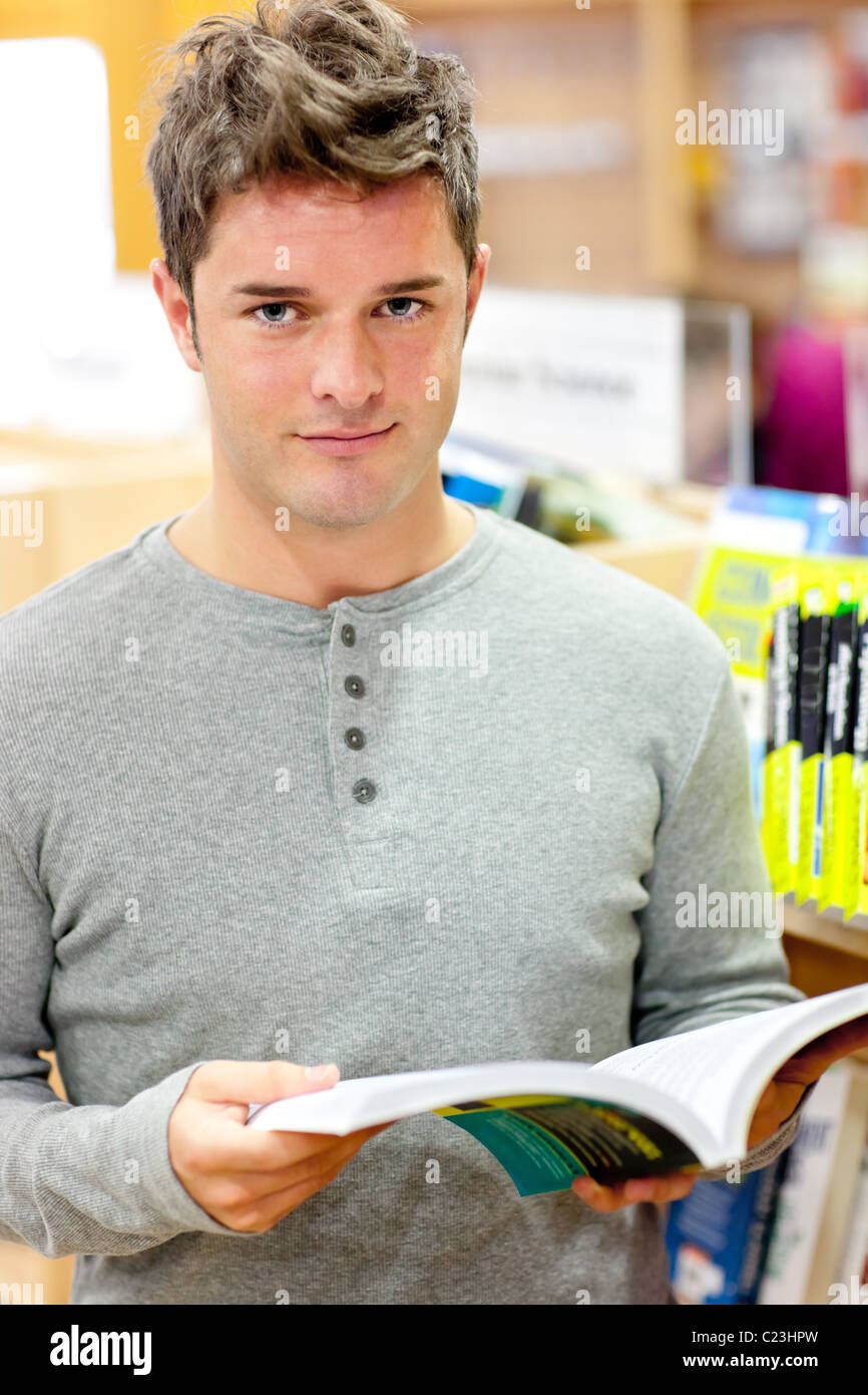 Serious young man reading a book Stock Photo - Alamy