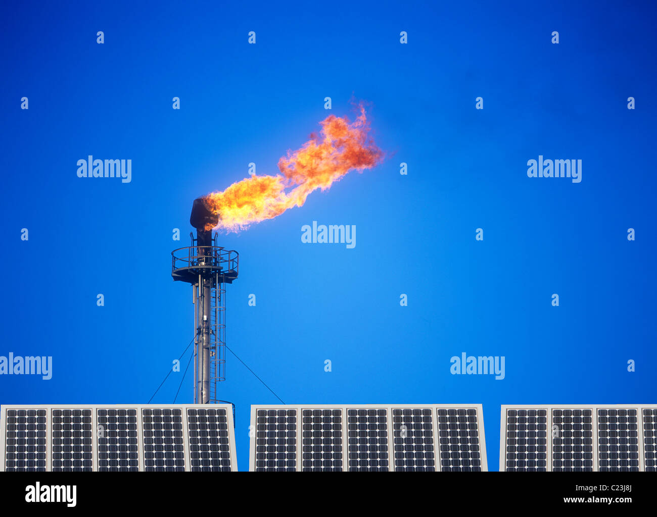A flare off of gas at a petrochemical works on Teeside, UK with solar ...