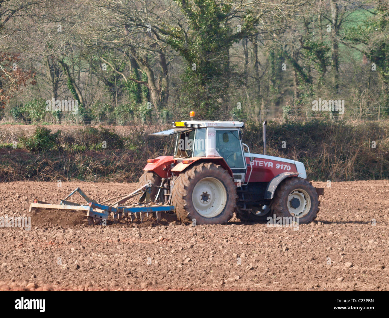 Tractor tilling the field, Devon, UK Stock Photo - Alamy