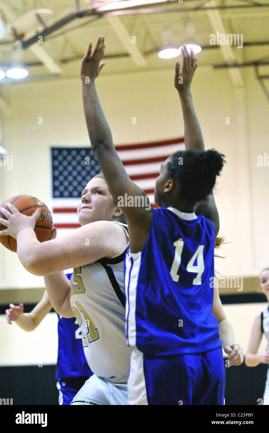 Female player eyes her target while in the process of delivering a shot ...