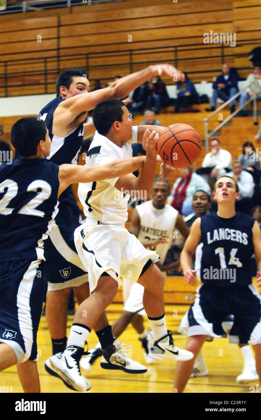 A trio of defenders converge on a player as he runs the gauntlet in the ...