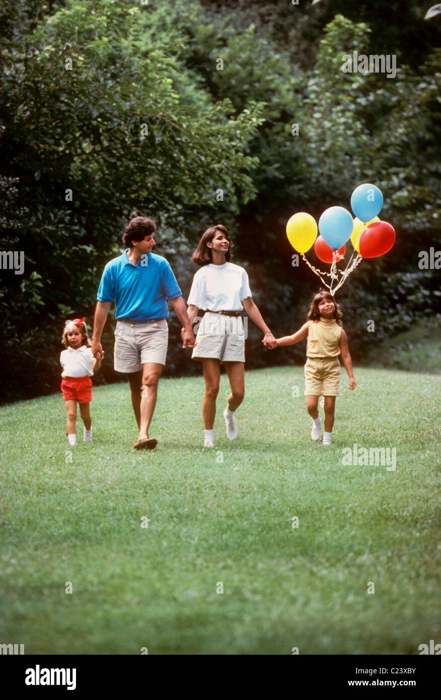 Family taking walk outdoors Stock Photo - Alamy