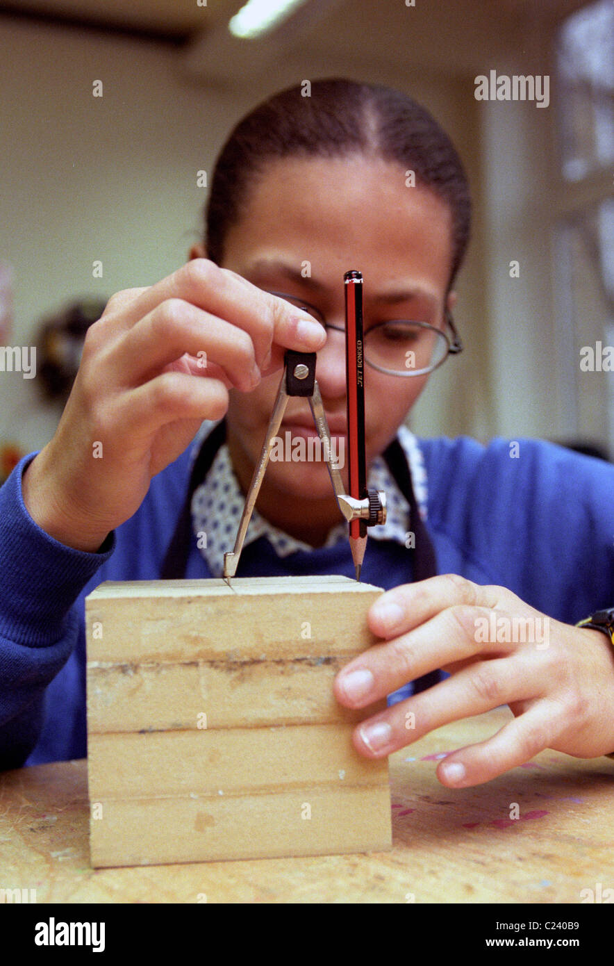Young student in constructing a model in wood lesson at College of ...