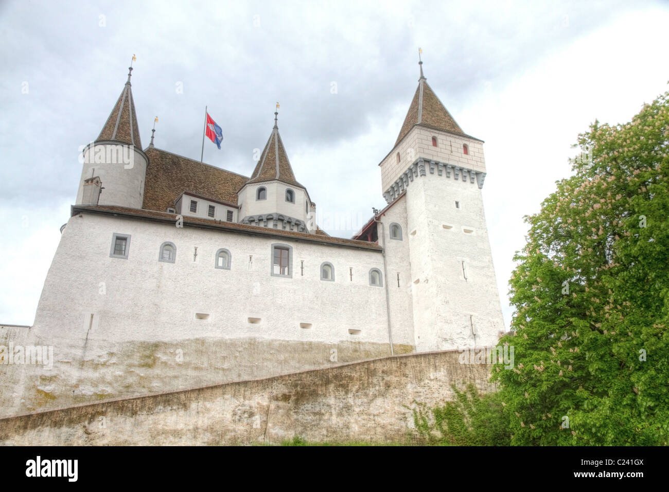 five towered white fairy tale castle Nyon standing on a lake geneva ...
