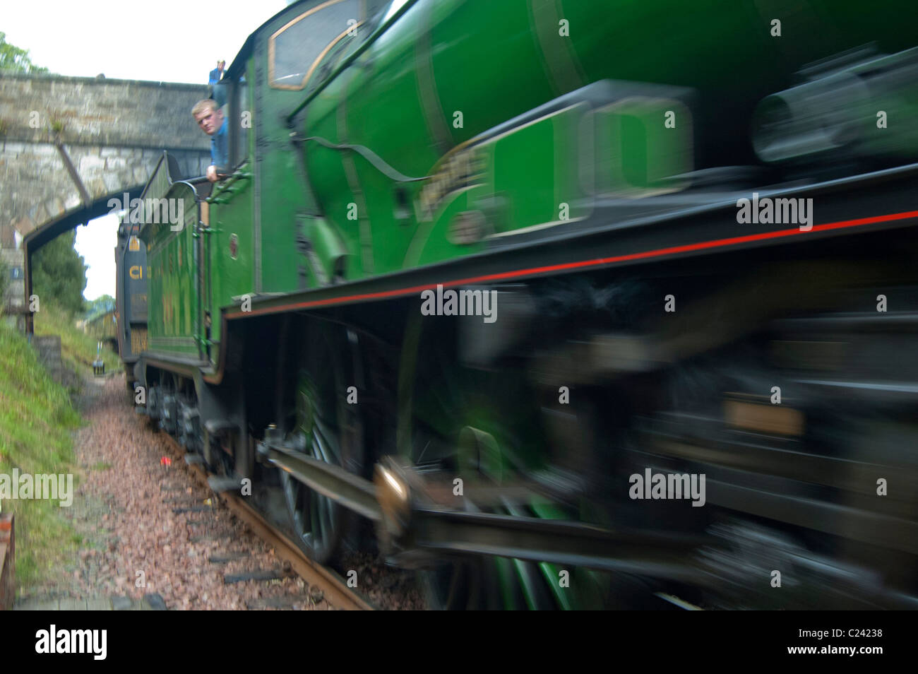 Steam train coming into a station Stock Photo - Alamy