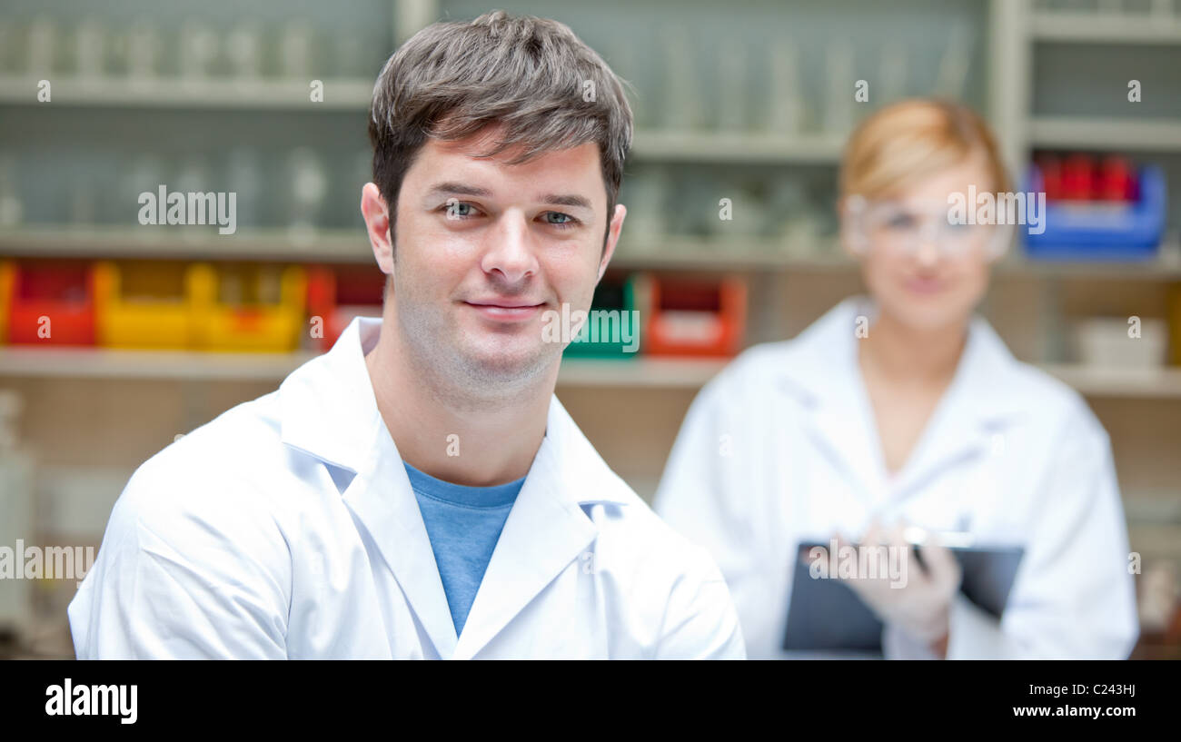 Two concentrated scientists looking at the camera Stock Photo - Alamy