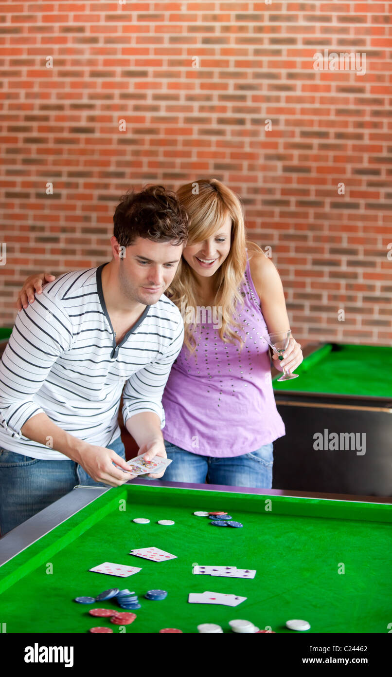 Cheerful couple playing cards on a billiard Stock Photo - Alamy