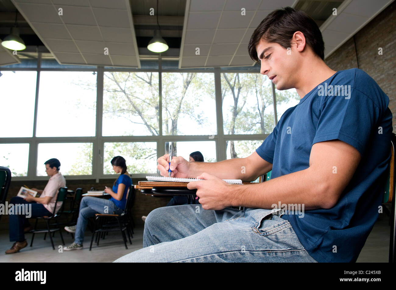 Male university student in a classroom Stock Photo - Alamy