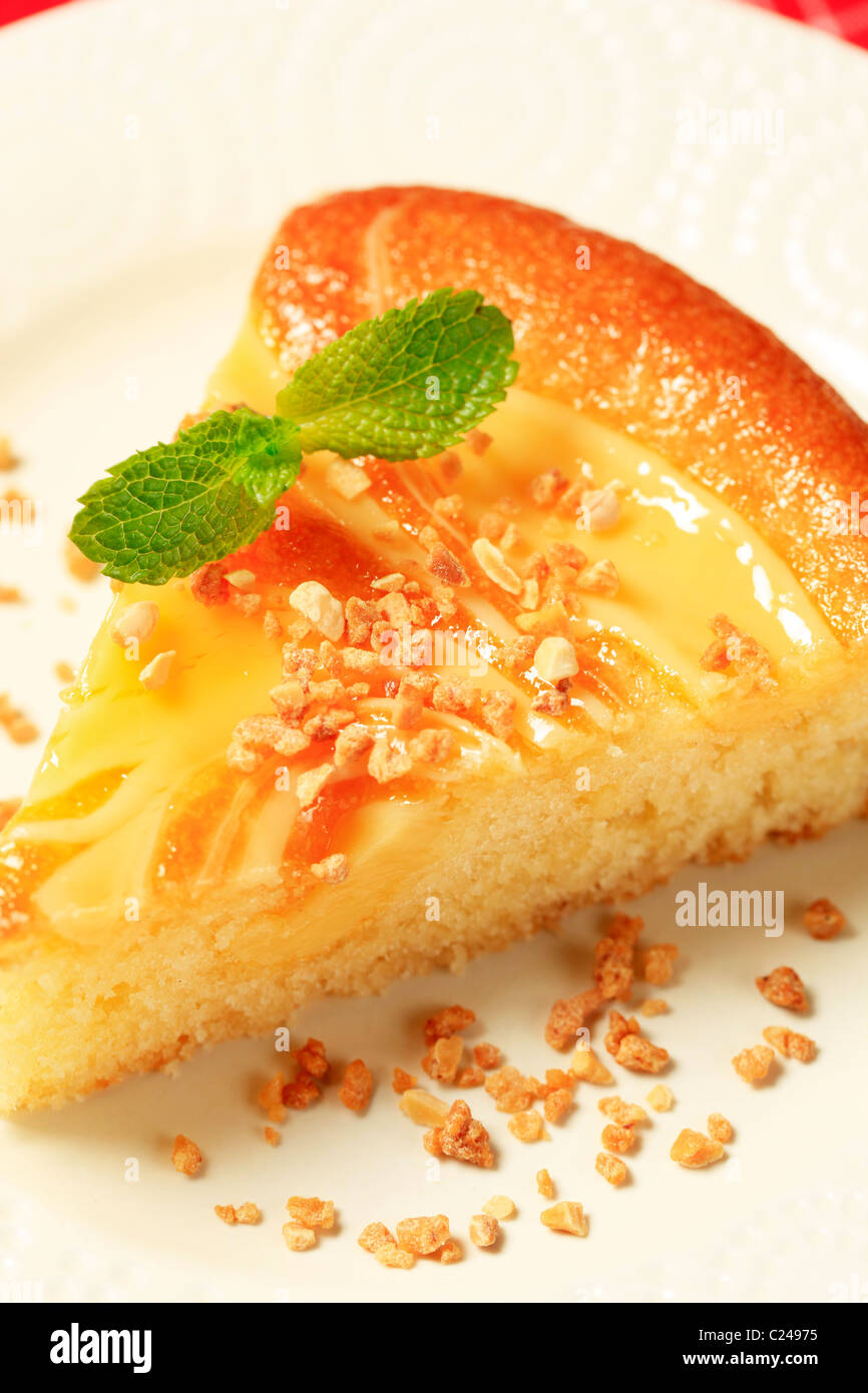 Sponge cake with custard sprinkled with nuts Stock Photo - Alamy