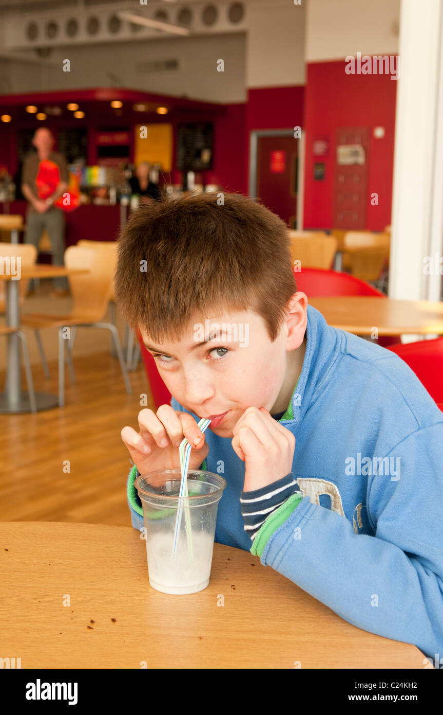 A boy drinking a milkshake in Sainsburys cafe at Longwater Retail Park ...