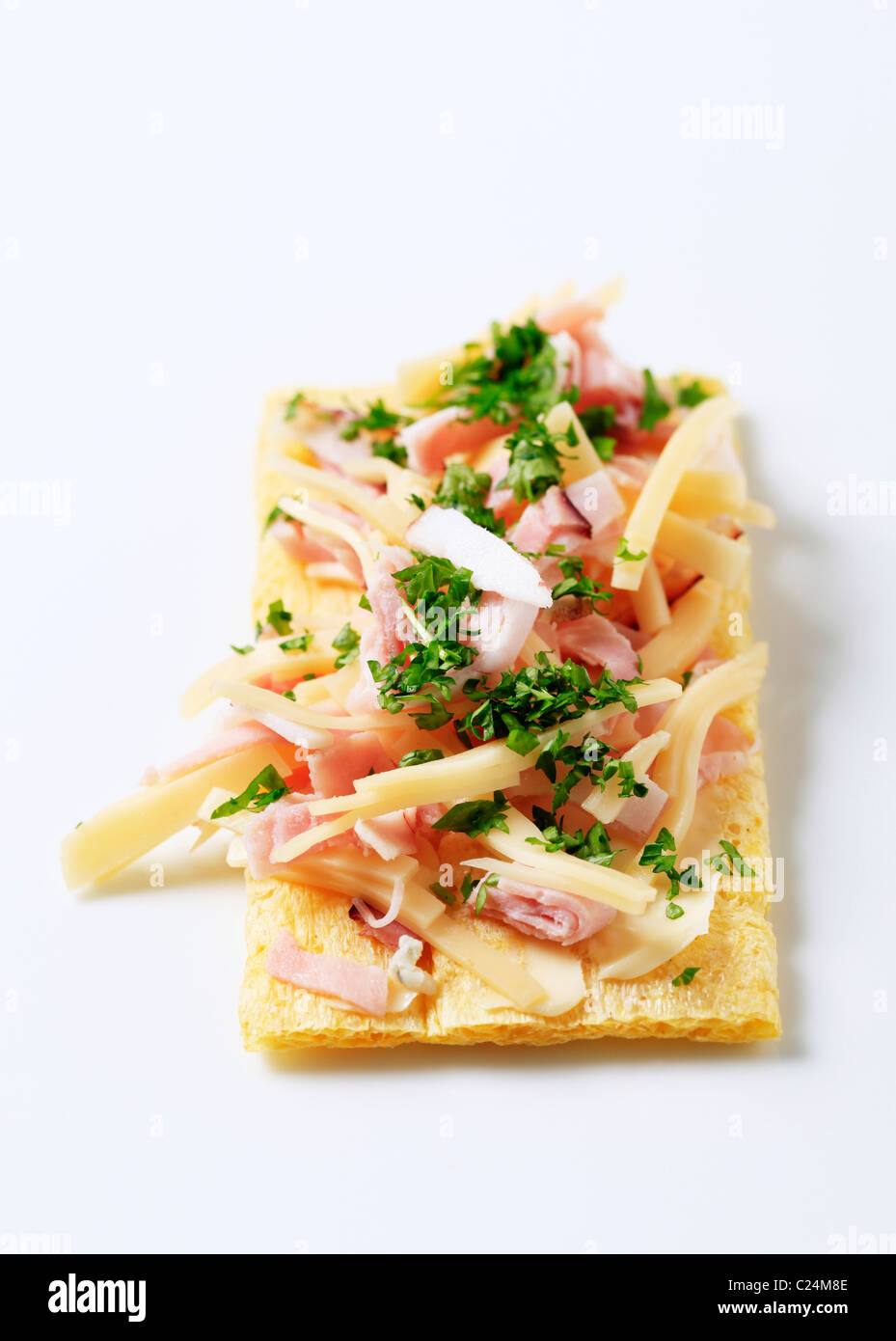 Crispbread with ham and cheese topping - studio Stock Photo - Alamy