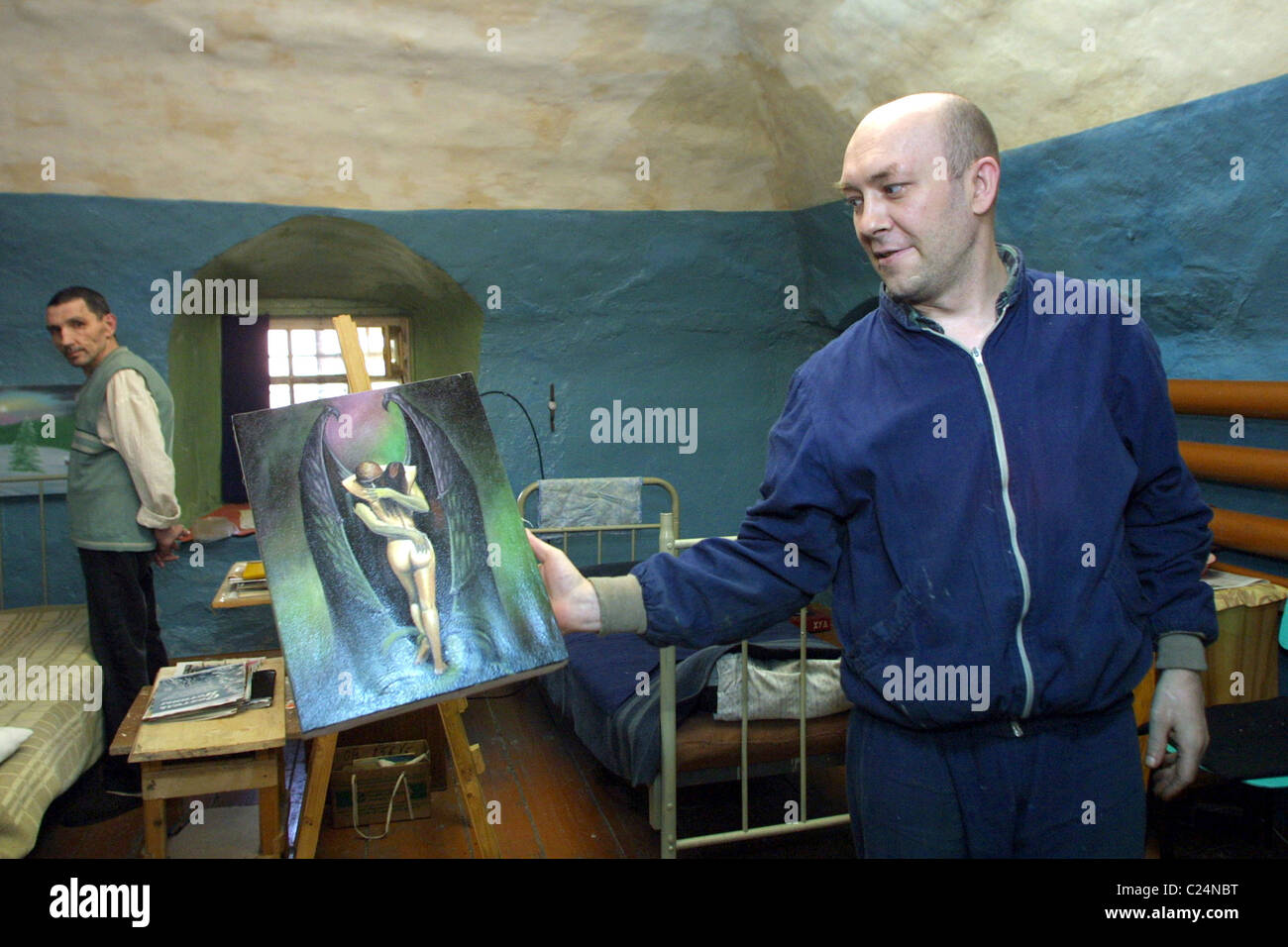 Prisoners in prison workshop where they work - sew uniform on machines ...