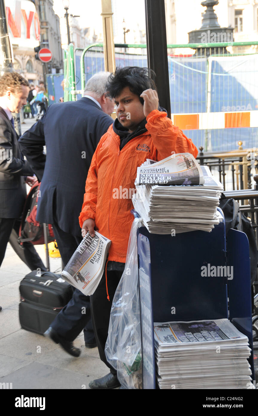 The Evening Standard newspaper paper distributor London bored tired ...