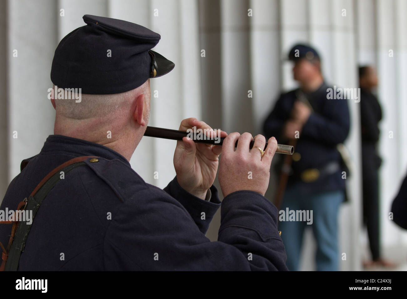 A piper dressed in a Union Army uniform performs during a ceremony at ...