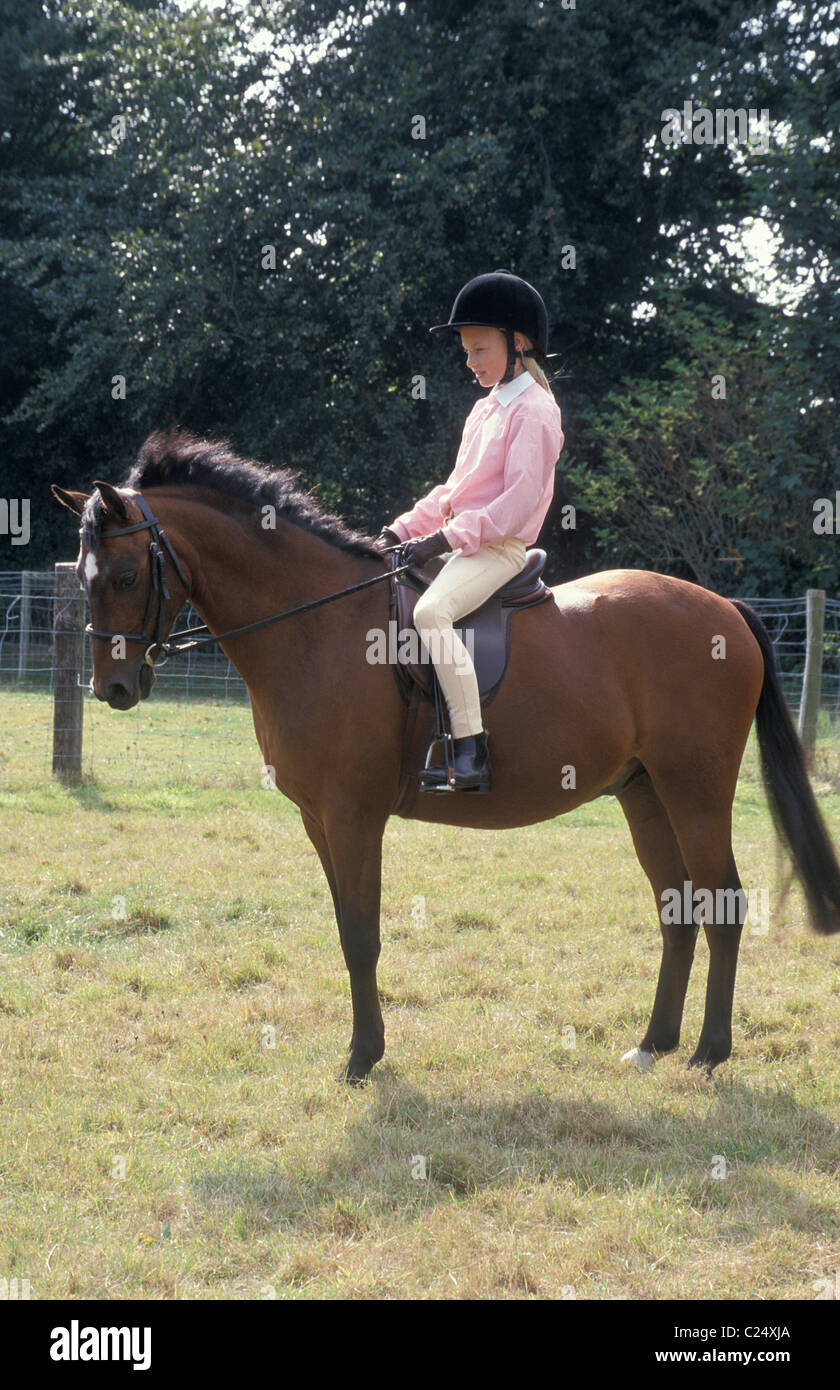 young girl riding her pony Stock Photo - Alamy