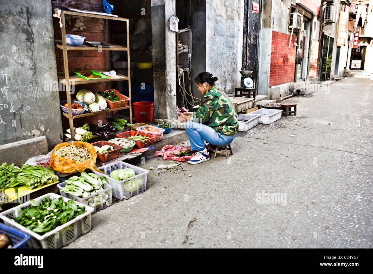 CHINA, WUHAN: Street scene in Wuhan alley with vegetables displayed on ...