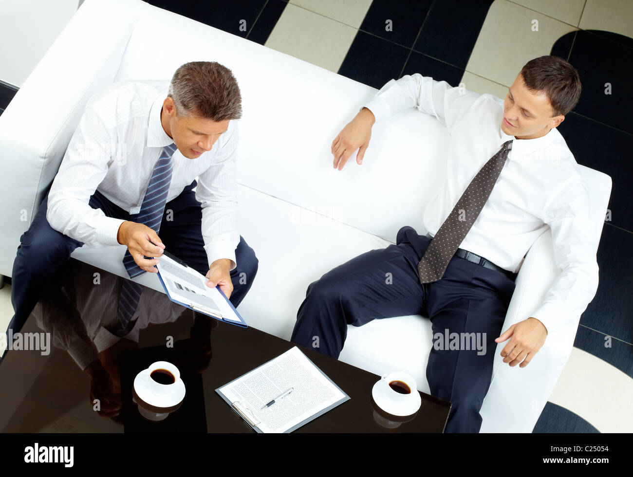 Image of two business partners discussing work at meeting Stock Photo ...