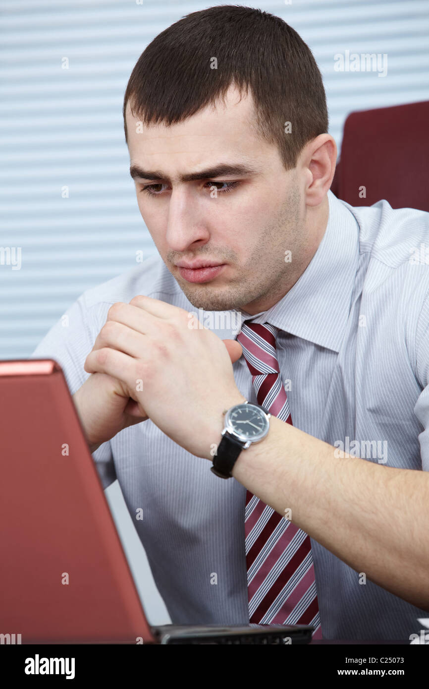 Portrait of a worried businessman looking at computer screen Stock ...