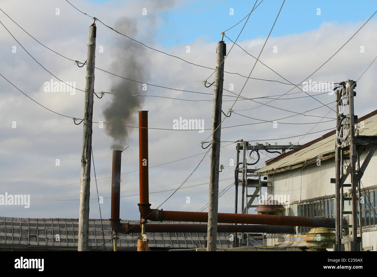 Black smoke from the exhaust pipe of a stationary diesel generator ...