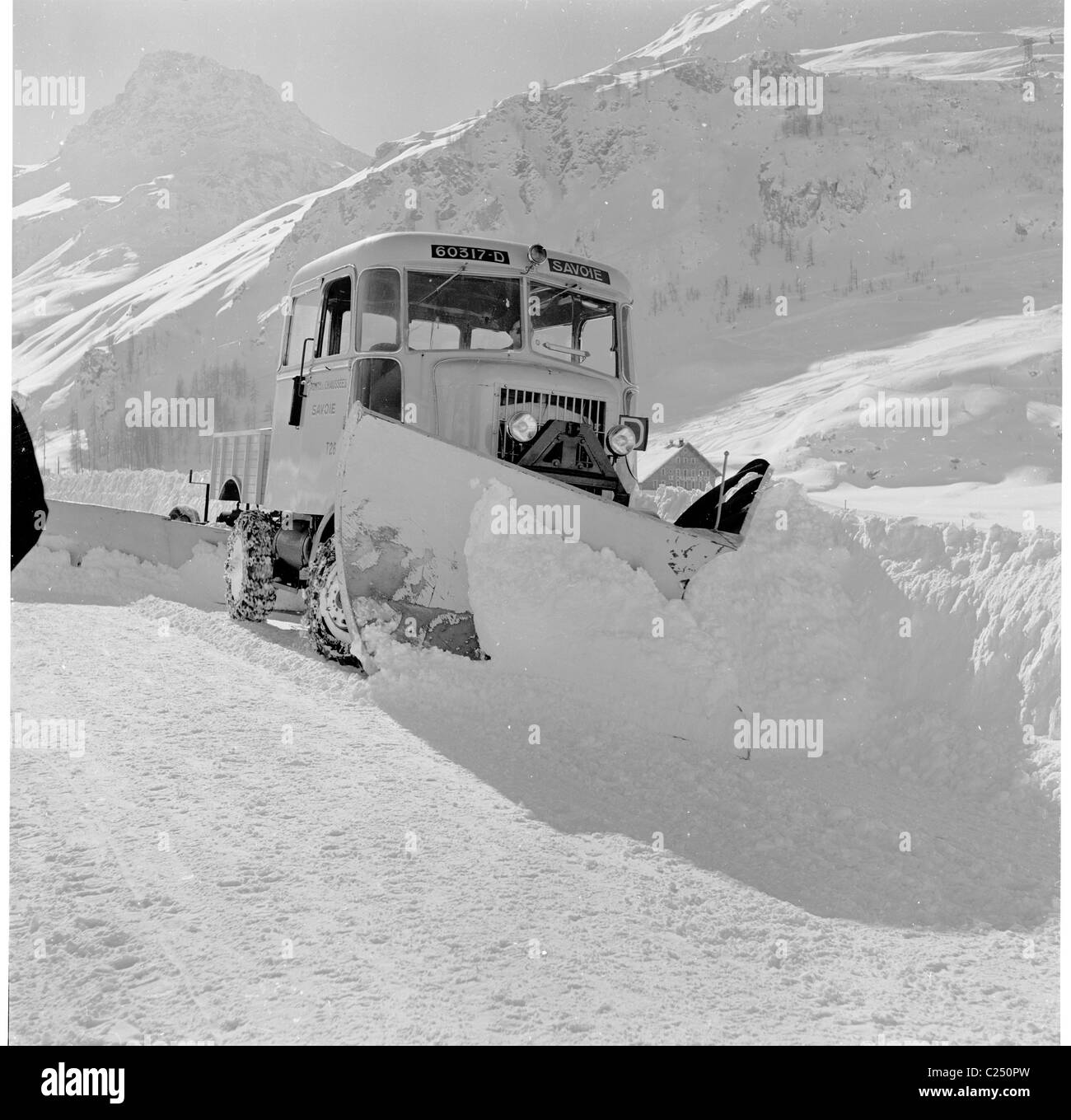 France,1950s. A truck with a plough for removing snow sits on a snow ...