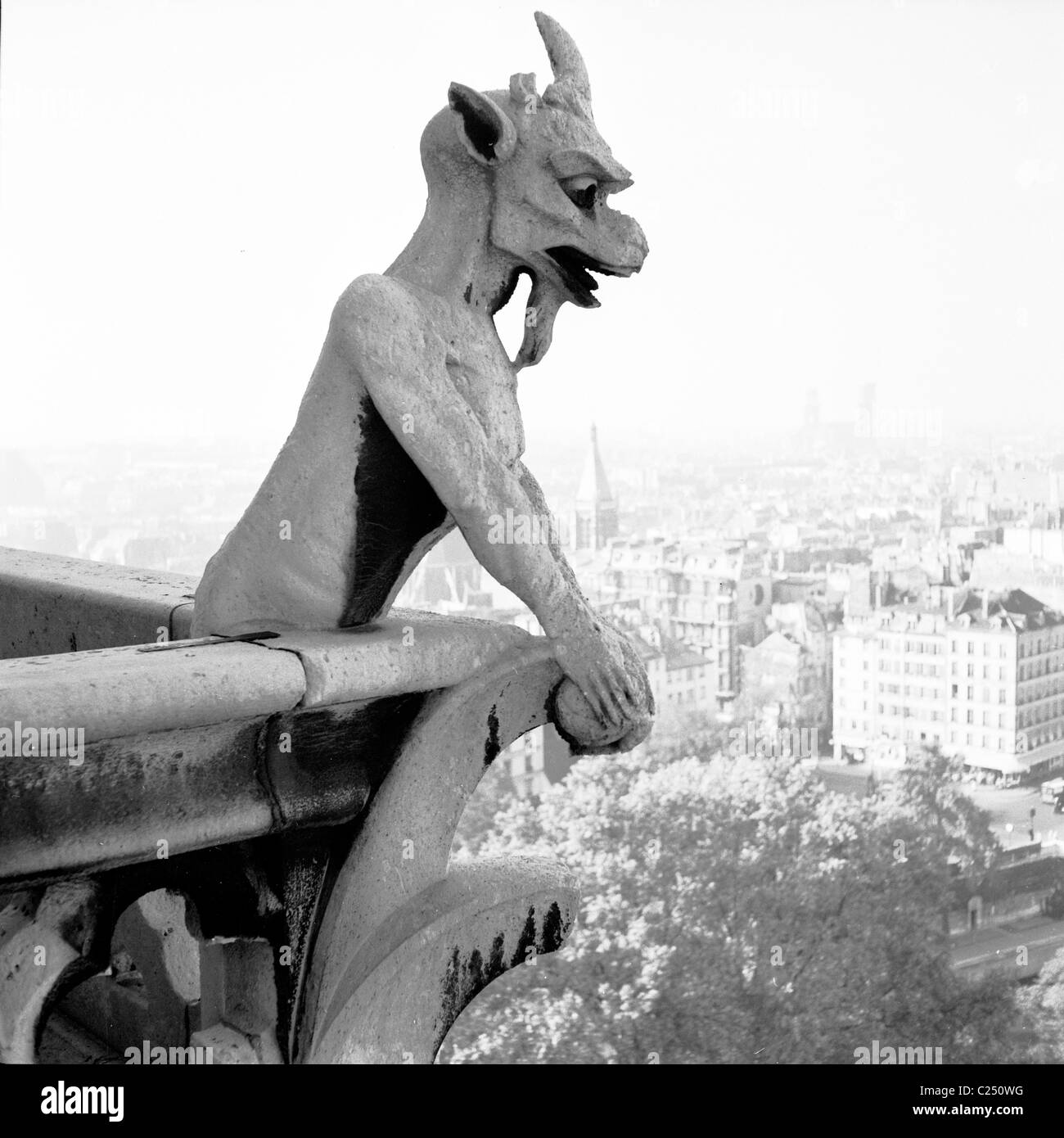 1950s, a chimera on the Notre-Dame Cathedral above the city of Paris ...