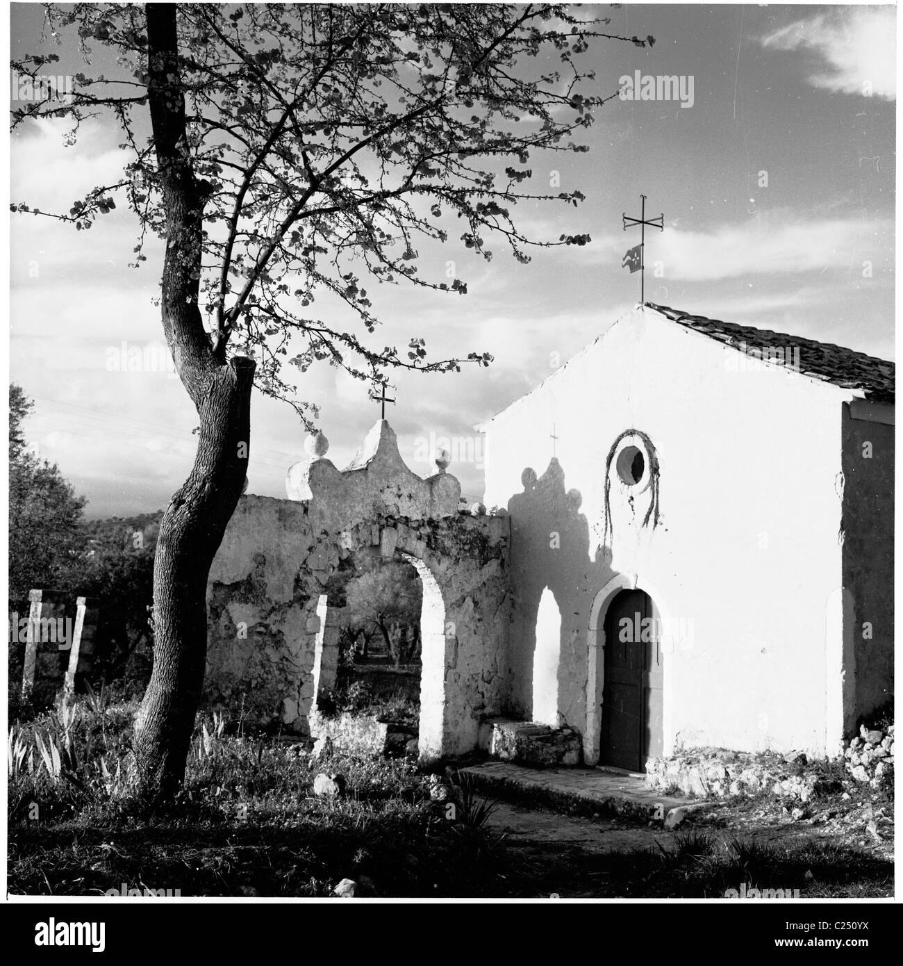 1950s, Greece. Pathway and Entrance to an old chapel on the Greek ...
