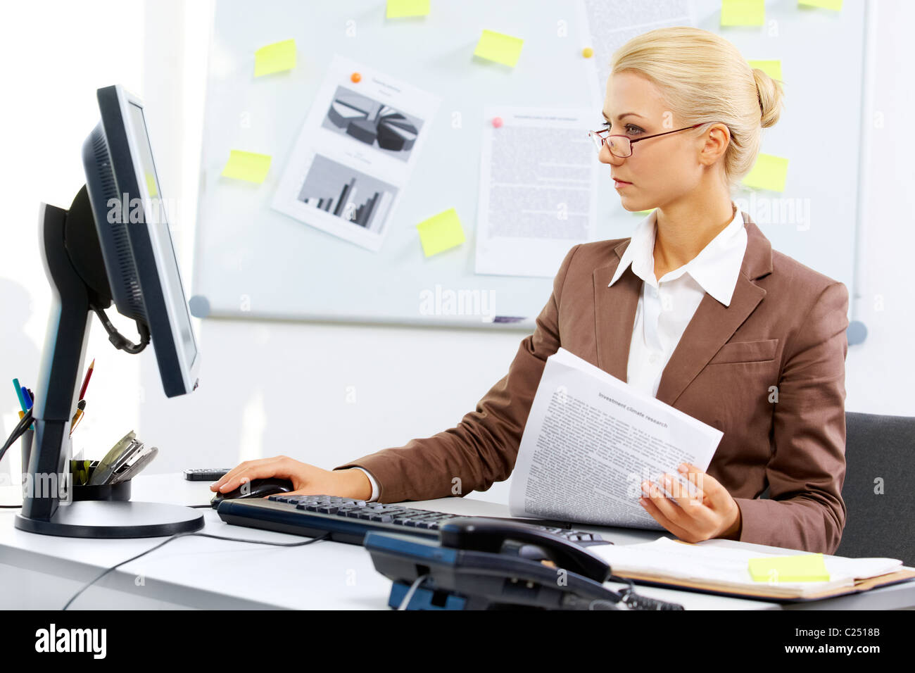 A young businesswoman looking at the monitor screen Stock Photo - Alamy