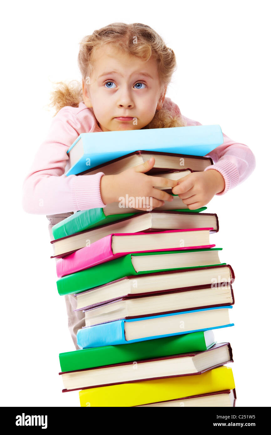 Portrait of a little girl trying to carry a huge heap of books Stock ...