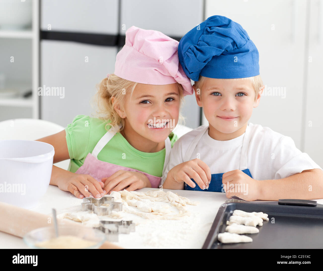 Portrait of two adorable children baking in the kitchen Stock Photo - Alamy