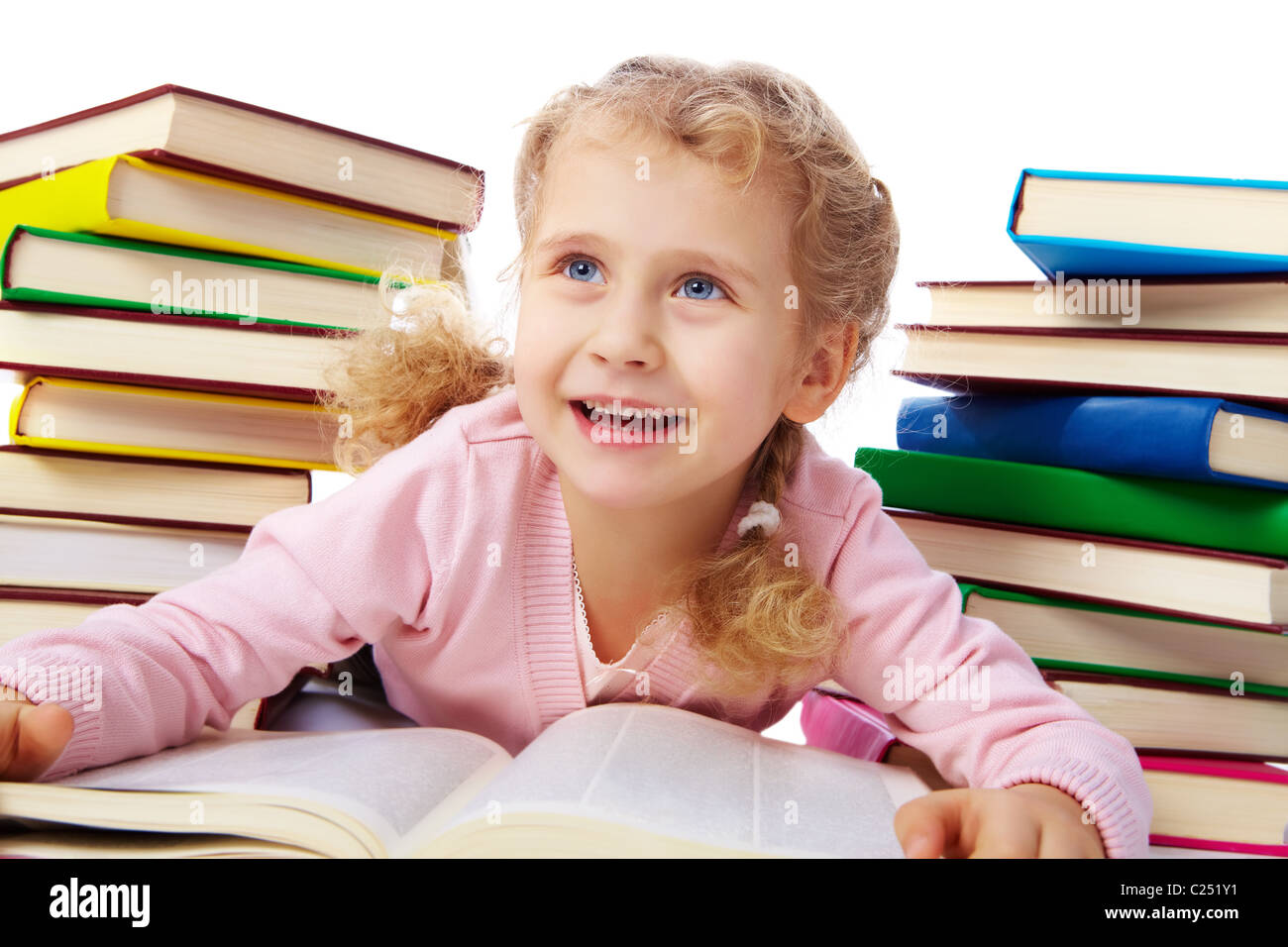 A little laughing girl reading a book Stock Photo - Alamy