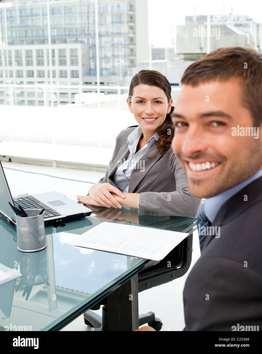 Two positive business people smiling at the camera Stock Photo - Alamy