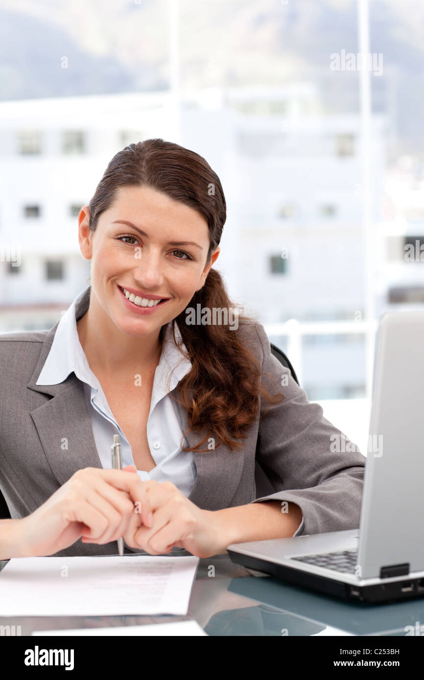 Pretty woman on the computer smiling at the camera Stock Photo - Alamy