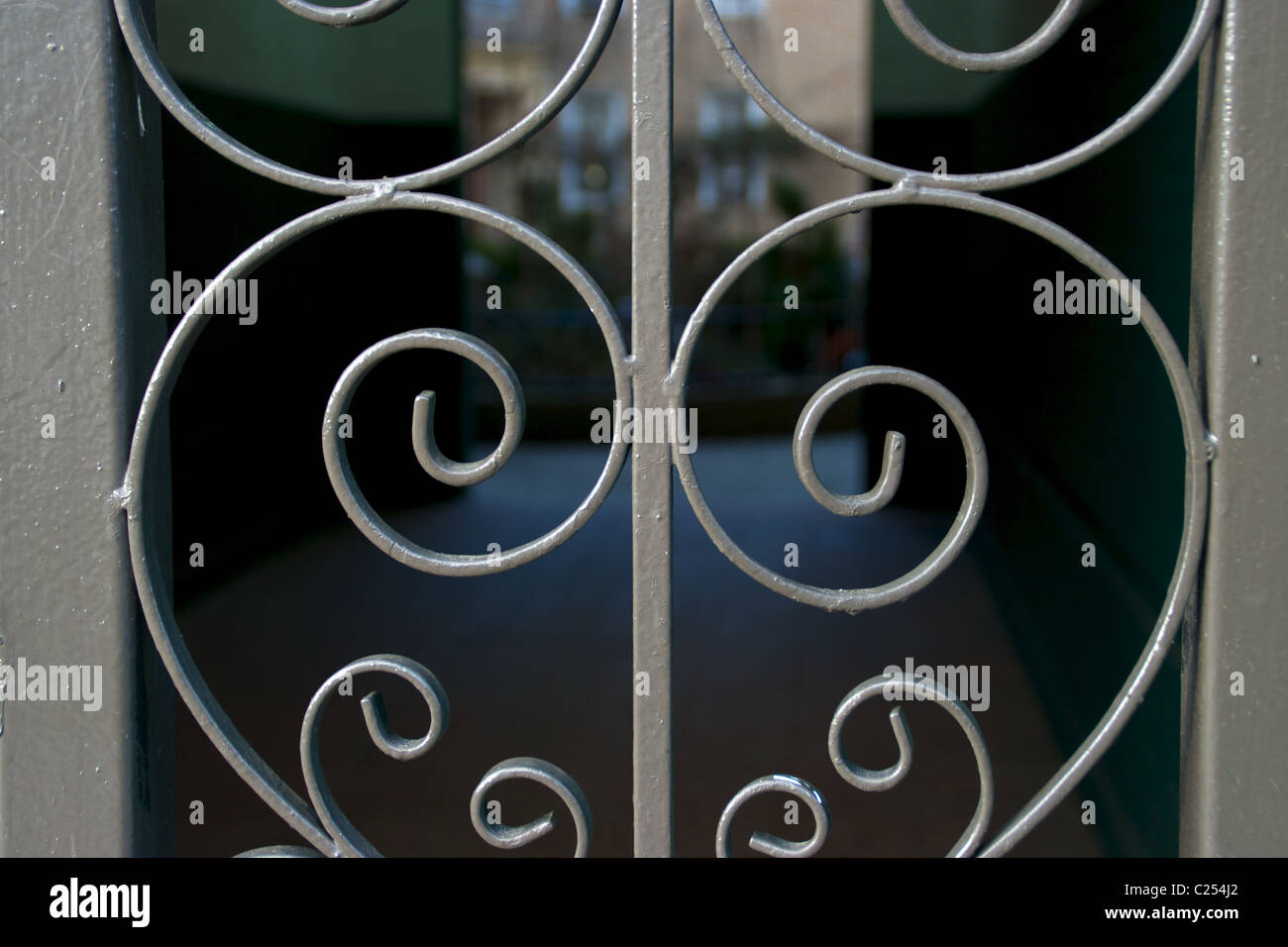 Iron gate with building in background Stock Photo - Alamy