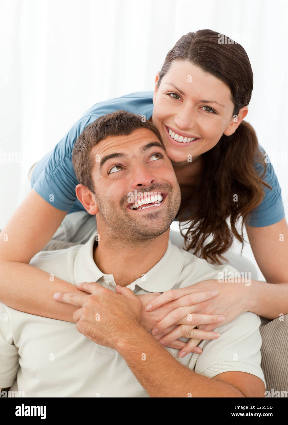 Portrait of a pretty woman hugging her husband Stock Photo - Alamy