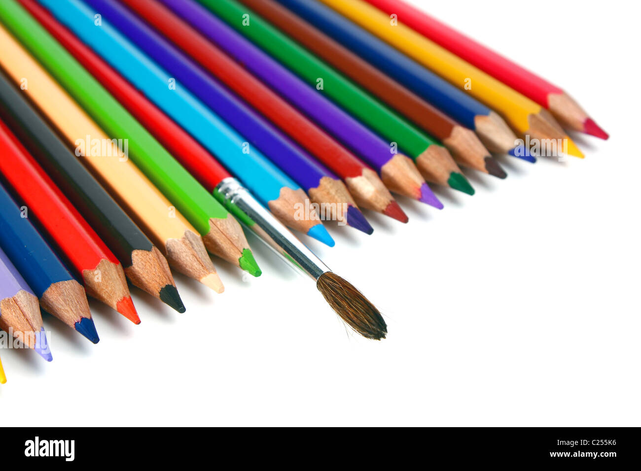 crayons coloured pencils and brush for paints isolated on white ...