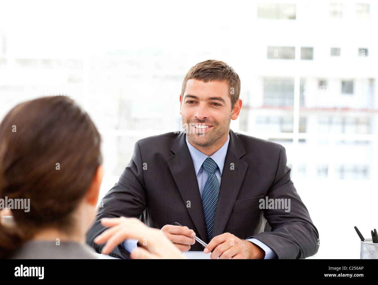 Two business people talking together during a meeting Stock Photo - Alamy
