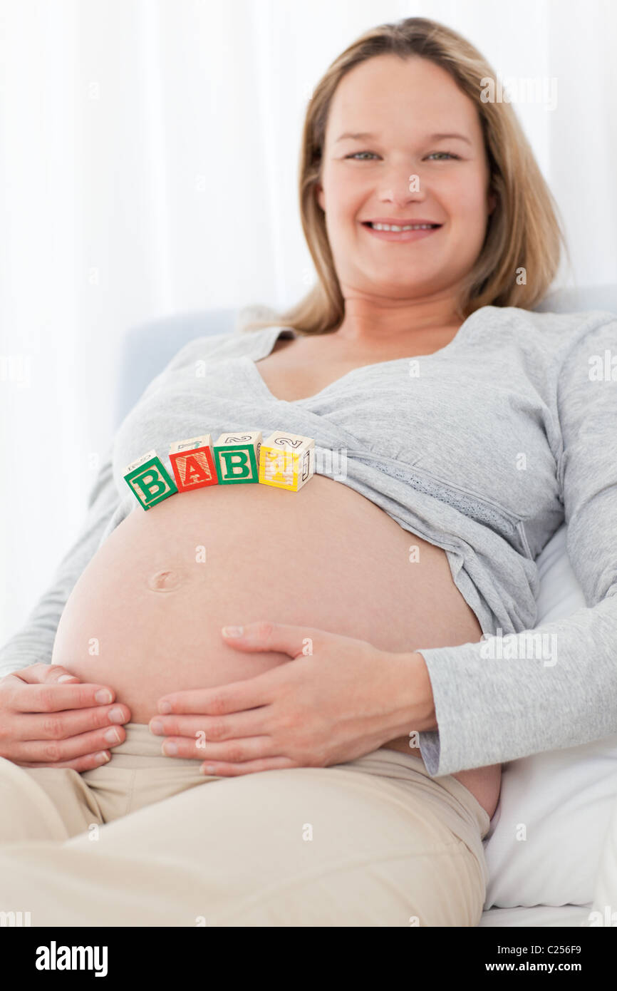 Cute pregnant woman with baby letters on her belly Stock Photo - Alamy