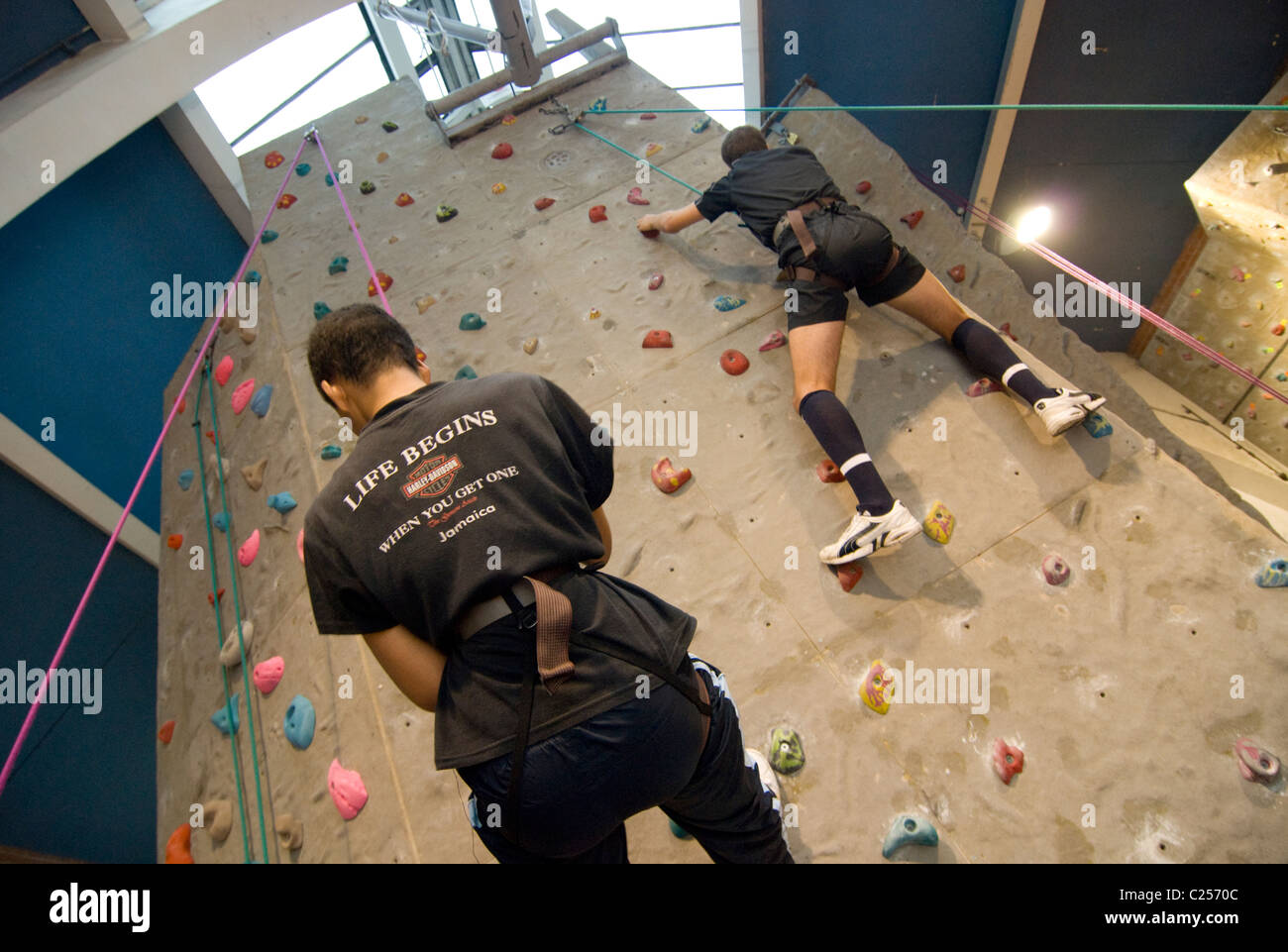 Boys using indoor climbing wall Stock Photo - Alamy